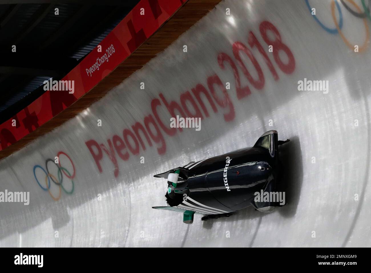 Nigeria's Seun Adigun and Akuoma Omeoga speed through the track during ...