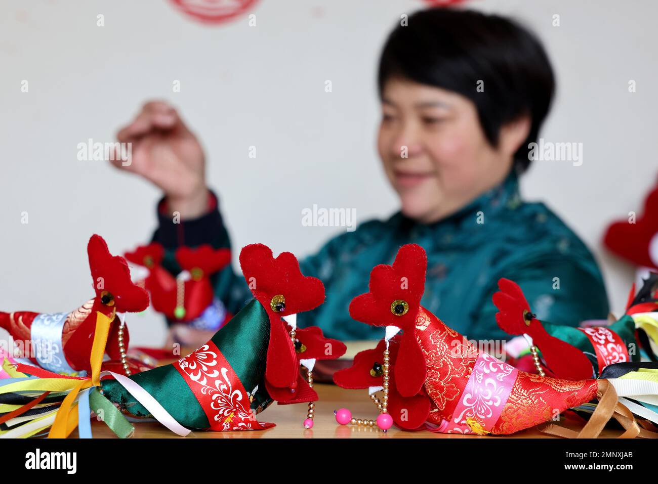 ZAOZHUANG, CHINA - JANUARY 31, 2023 - Folk craftsman Zhao Ruixue sews ...