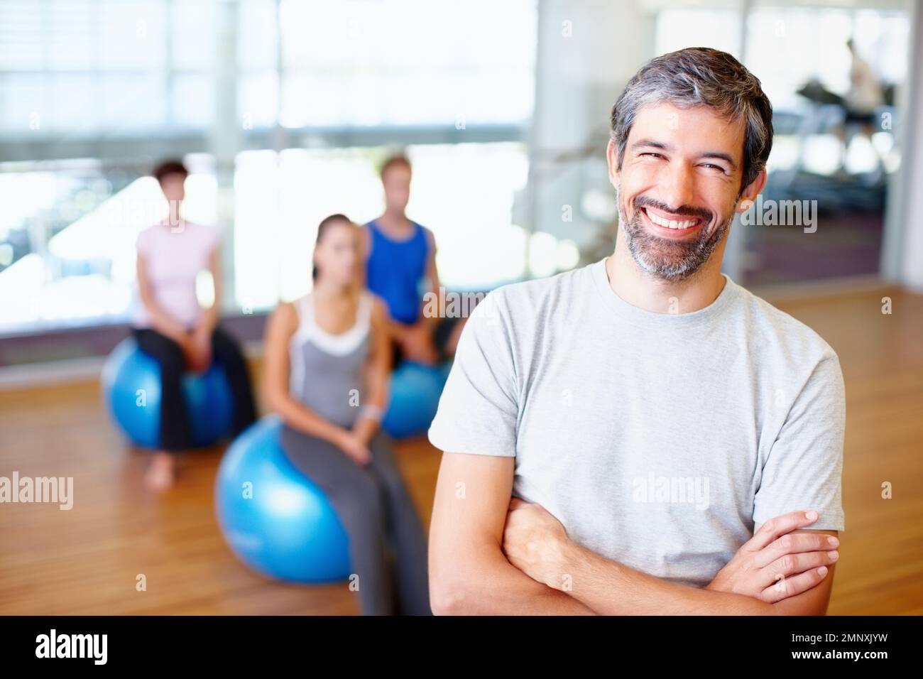 Confident male trainer smiling. Portrait of smiling male gym trainer ...