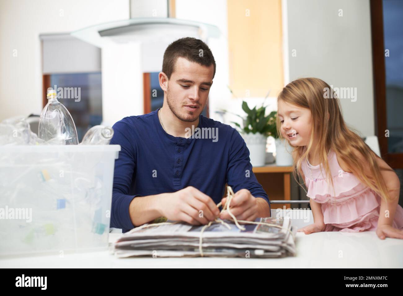 Teach me how to do it daddy..A young eco-friendly family working ...