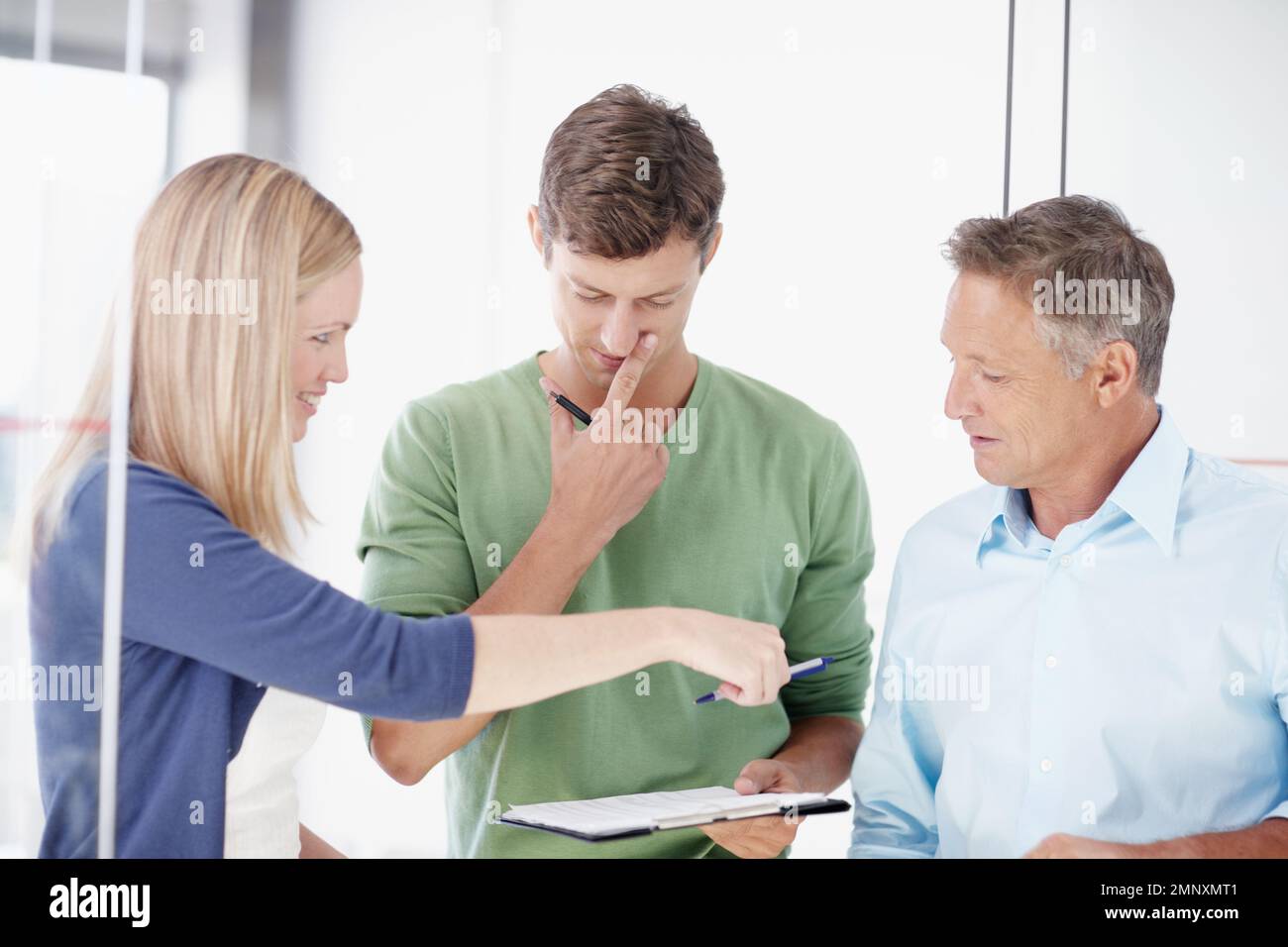 They work better as a team. Three work colleagues discussing something ...