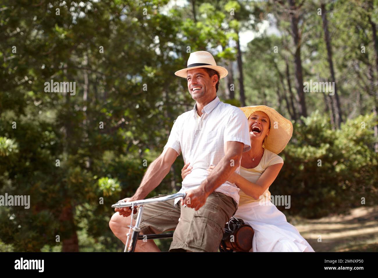 Having a blast together. Playful couple having fun while riding on ...