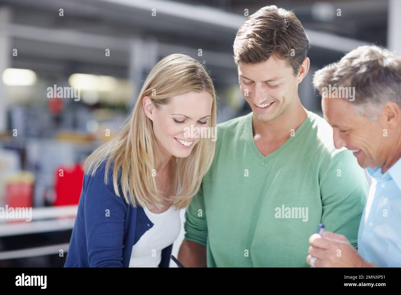 Getting things done as a team. Three work colleagues discussing ...