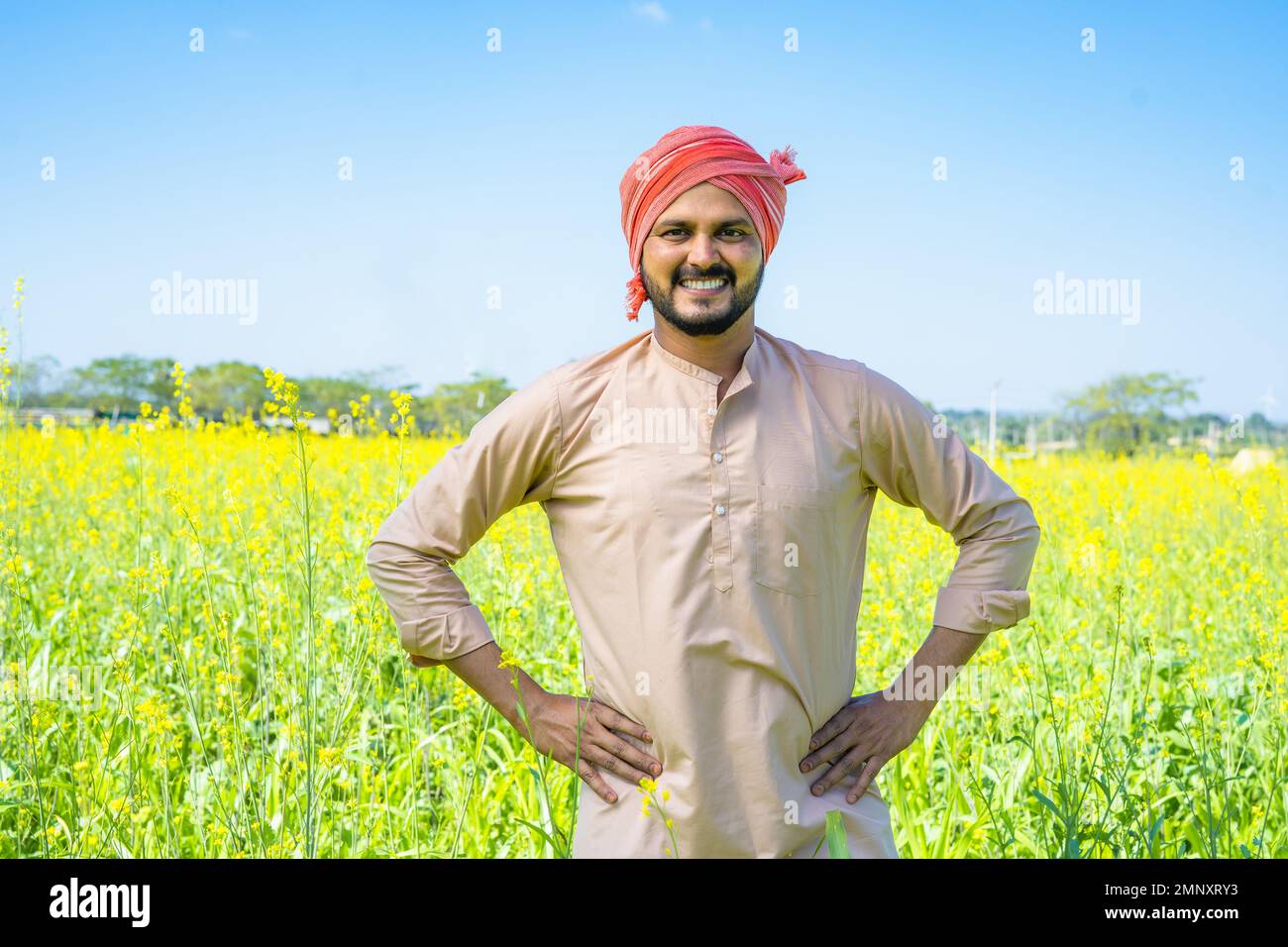 Portrait shot of Happy young farmer confidently standing by looking ...