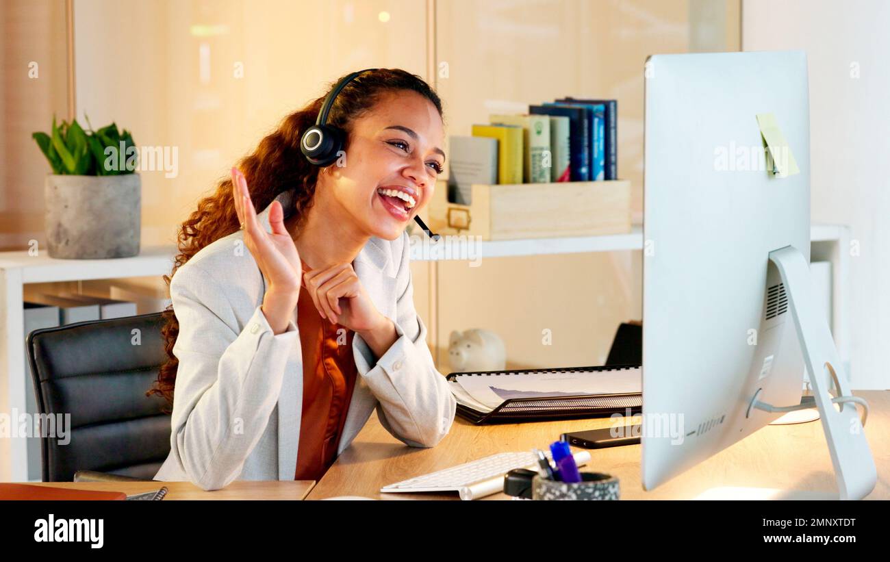 A happy modern business woman having an online meeting at her computer ...
