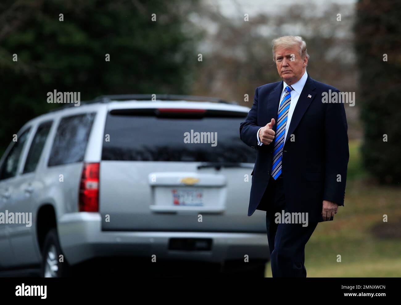 President Donald Trump flashes a thumbs up as he leaves the White House ...
