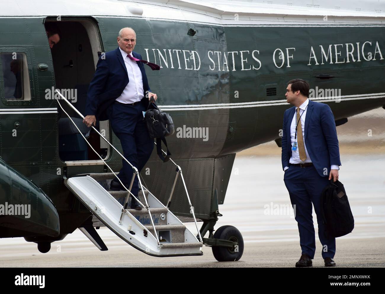 White House Chief of Staff John Kelly, left, walks off of Marine One as ...