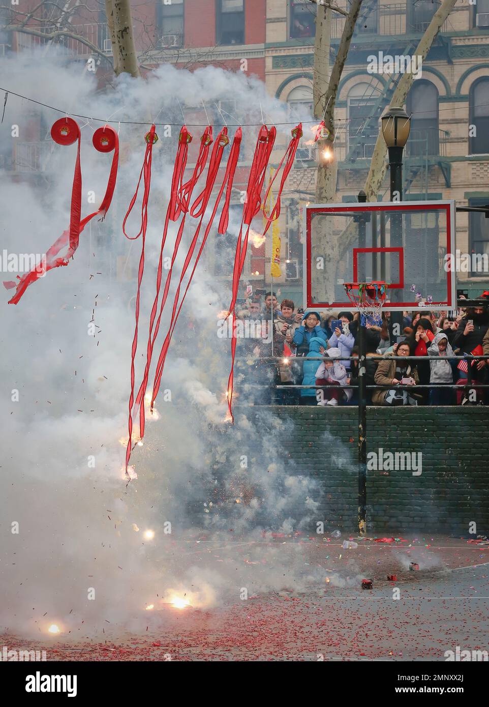 Rolls of firecrackers are set off during a firecracker ceremony hosted ...