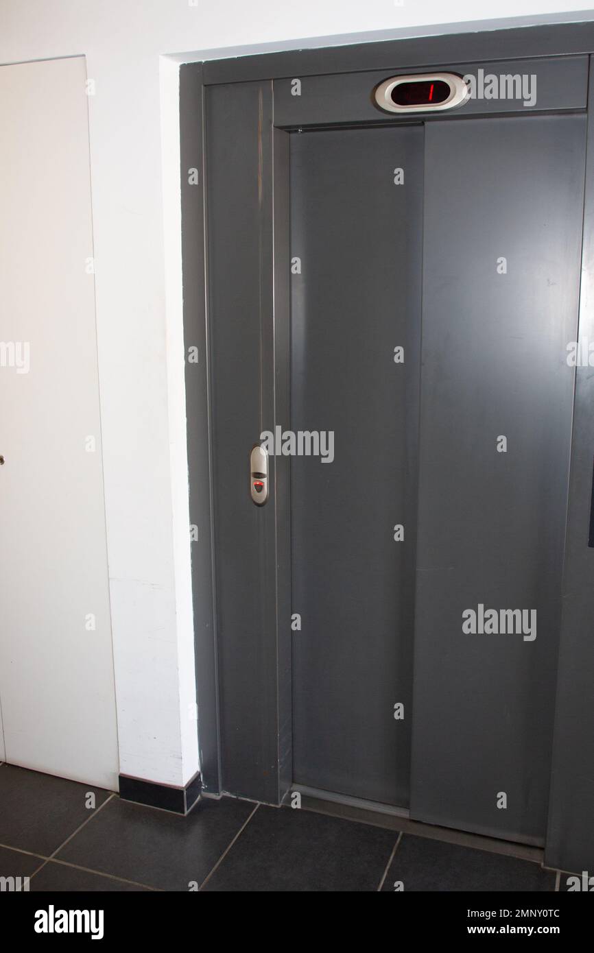 building lift Elevator Doors Closed grey in white wall Stock Photo - Alamy