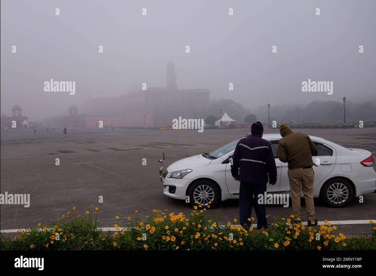 A traffic police officer talks to his colleagues sitting in his car ...