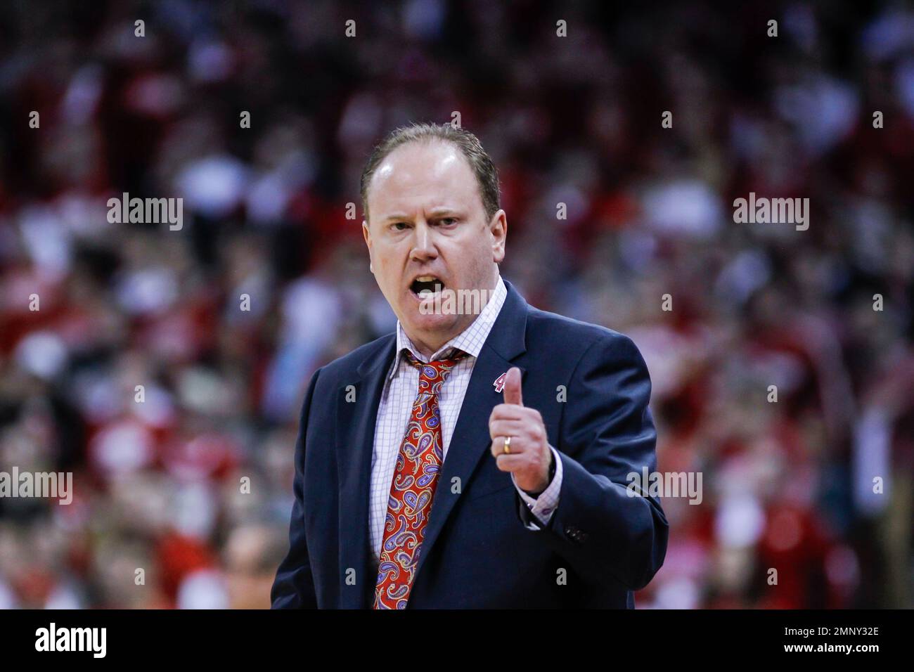 Wisconsin coach Greg Gard calls up a player from the bench during the ...