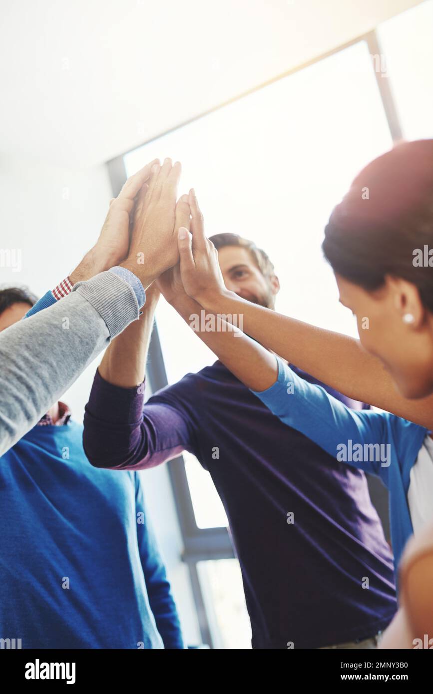 They make a great team. a group of businesspeople giving each other a ...