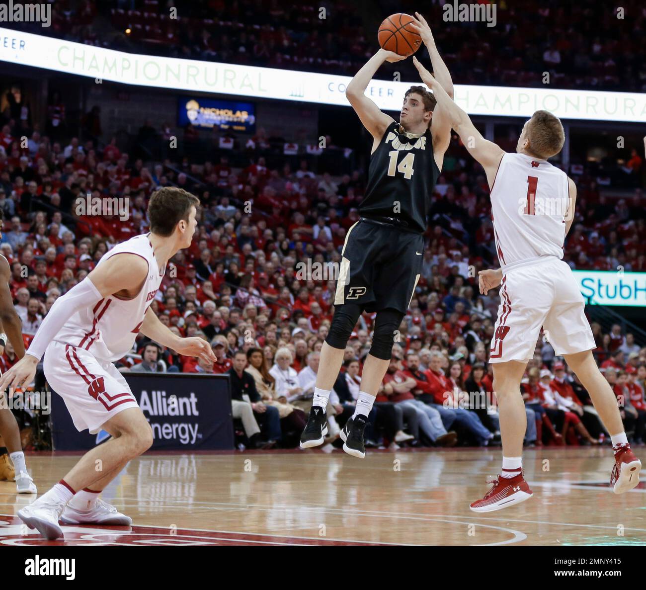 Purdue's Ryan Cline (14) shoots over Wisconsin's Brevin Pritzl (1) and ...