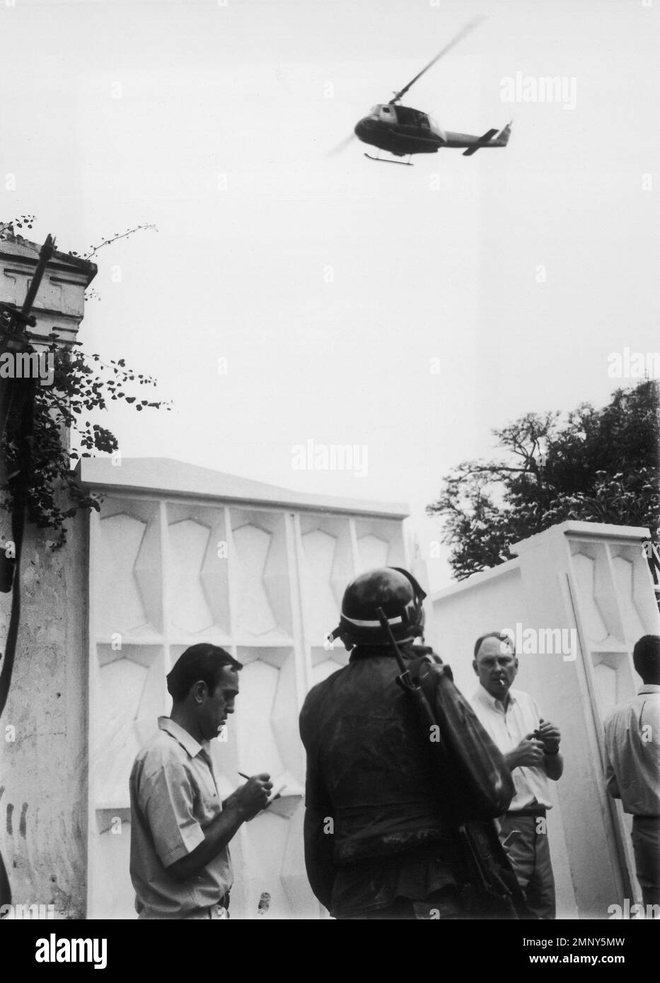 Associated Press correspondent Peter Arnett takes notes during a Viet ...