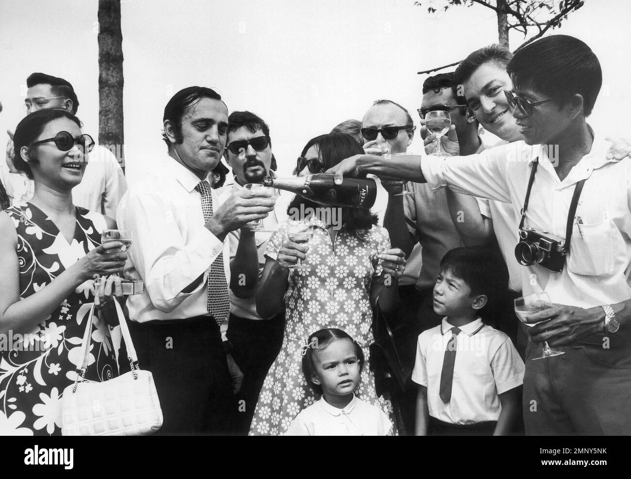 Associated Press staff photographer Dang Van Phuoc, far right, pours a ...