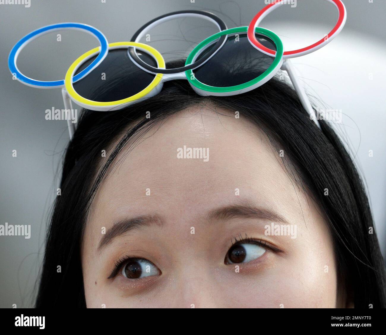 A fan watches the women's 15-kilometer individual biathlon at the 2018 ...