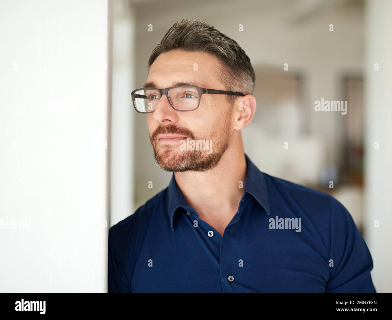 In a contemplative mood...a man leaning against a wall deep in thought ...