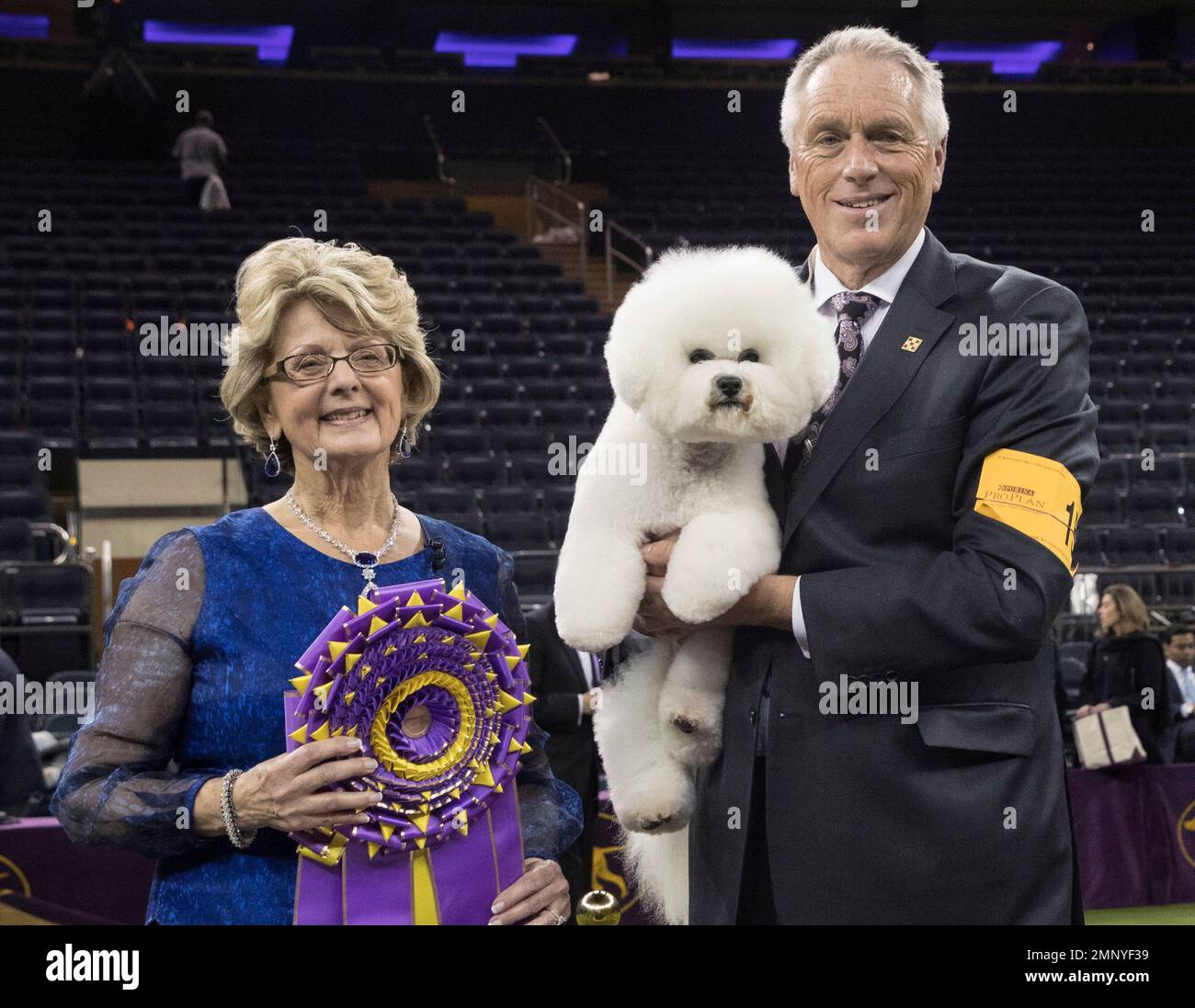 Handler Bill McFadden, right, poses for photos with Flynn, a bichon ...