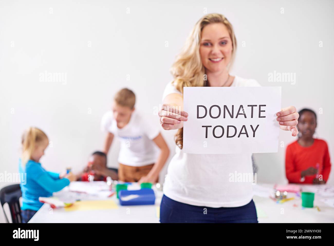 Even a little goes a long way. Portrait of a volunteer holding up a ...