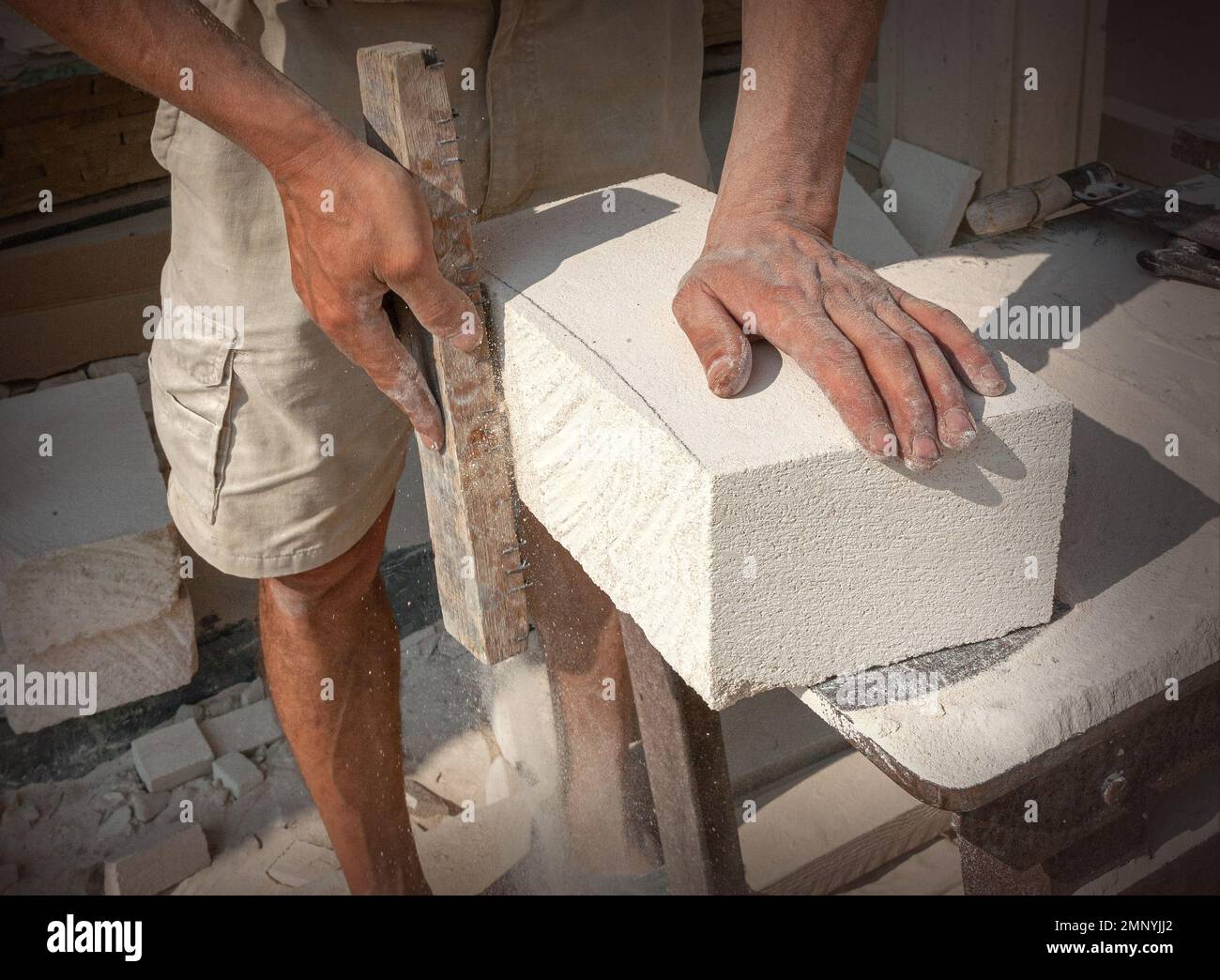 The sculptor's hands, which process a block of white stone on the ...