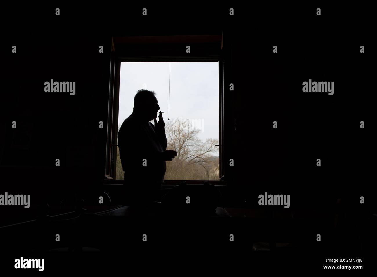 Man smoking at the window Stock Photo - Alamy