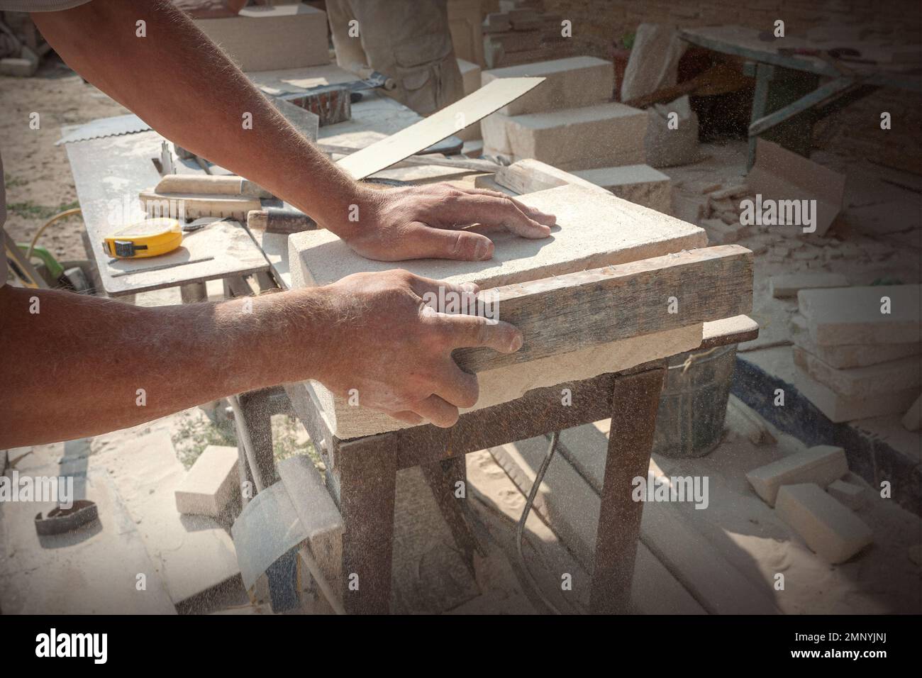 The sculptor's hands, which process a block of white stone on the ...