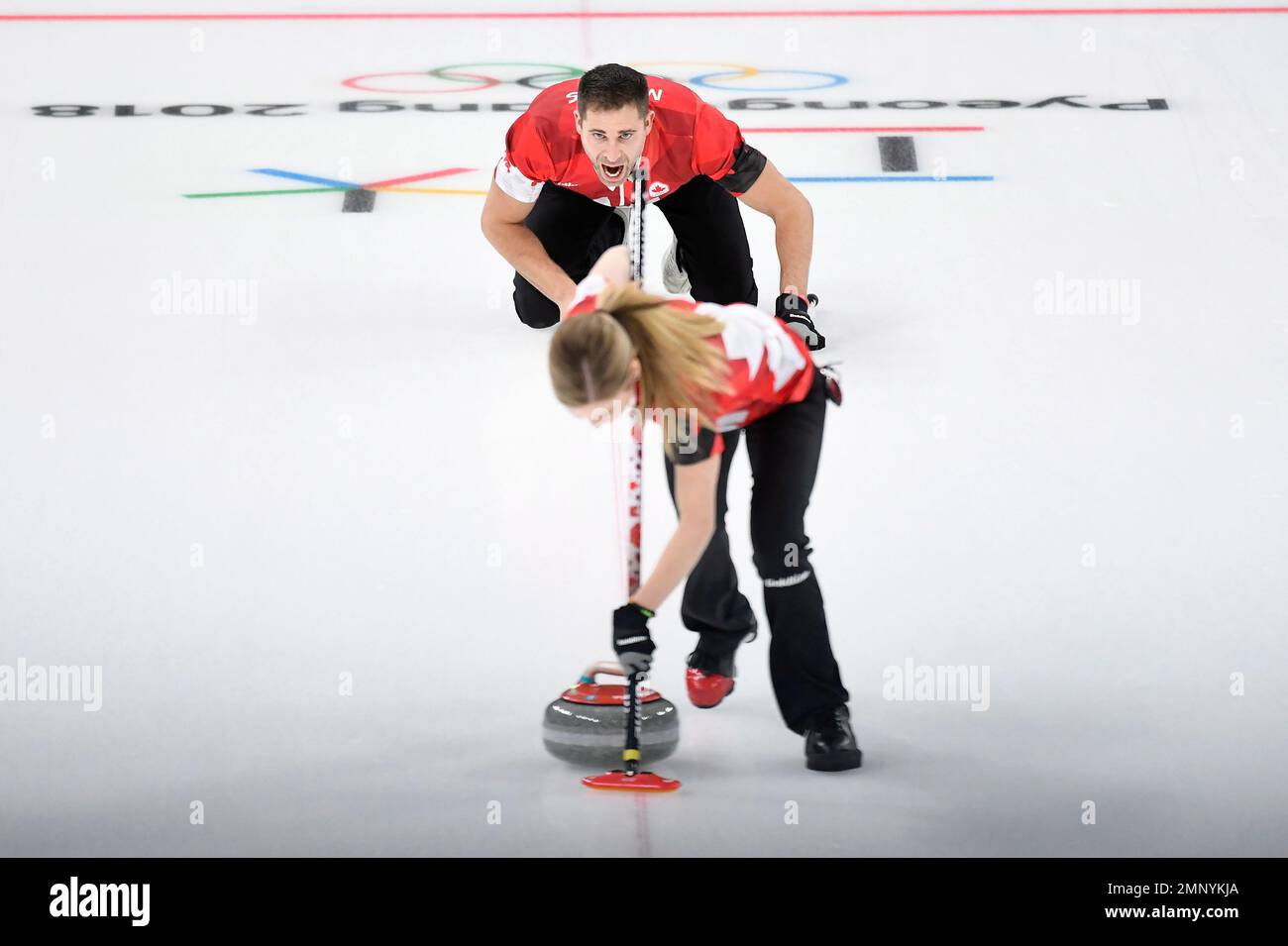 Canada's Kaitlyn Lawes and teammate John Morris play their stone during ...