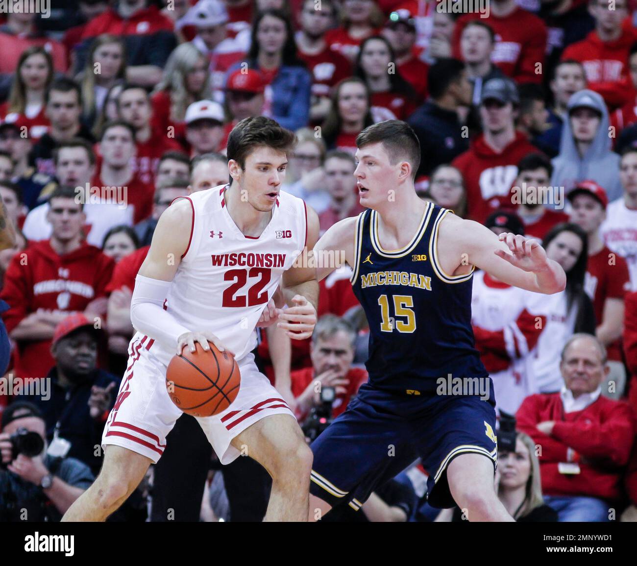 Wisconsin's Ethan Happ (22) and Michigan's Jon Teske (15) during the ...
