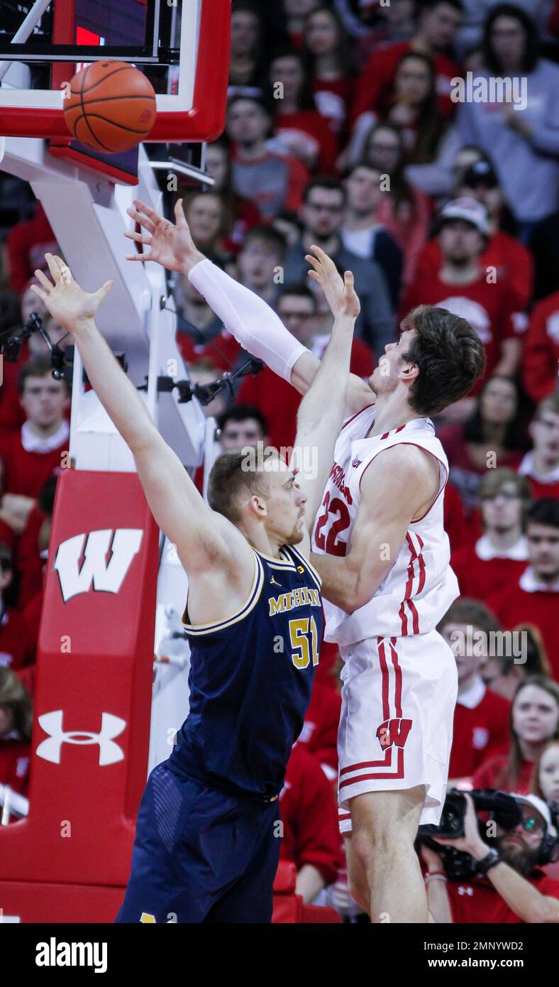Wisconsin's Ethan Happ (22) and Michigan's Austin Davis (51) during the ...