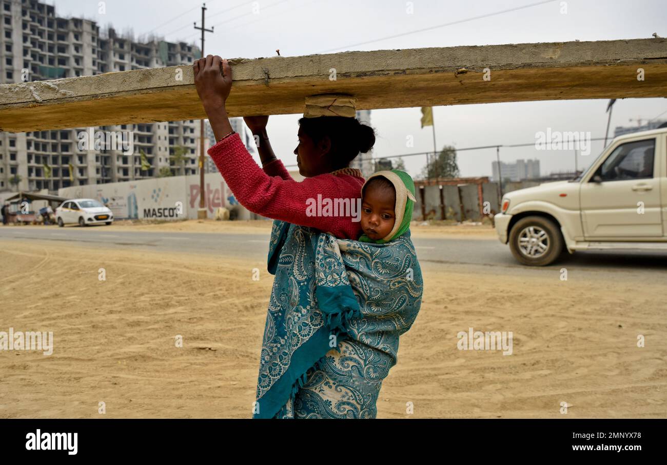 An Indian woman working at a building construction site has her ...