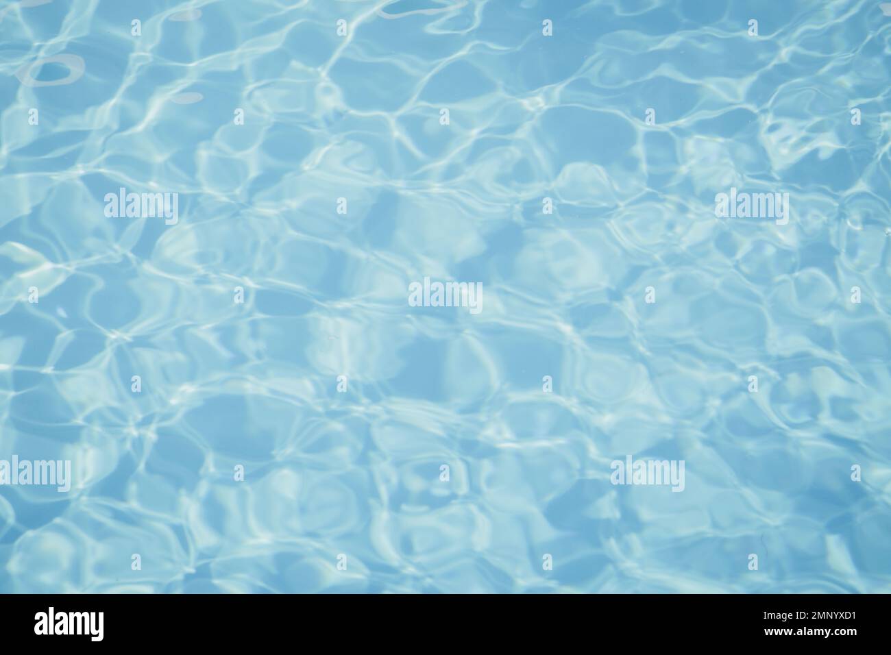 Blue pool water with sun reflections background Stock Photo - Alamy
