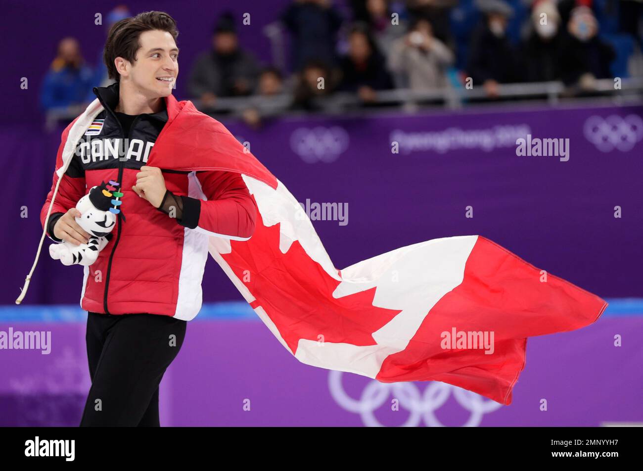 Canada's Scott Moir wears his national flag as he celebrates on the ice ...
