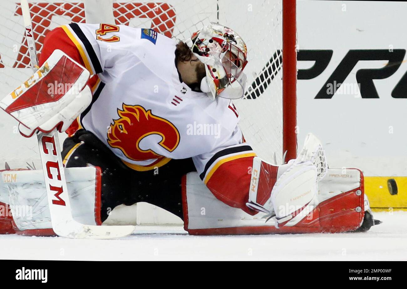 Calgary Flames goaltender Mike Smith (41) deflects the puck to make a ...