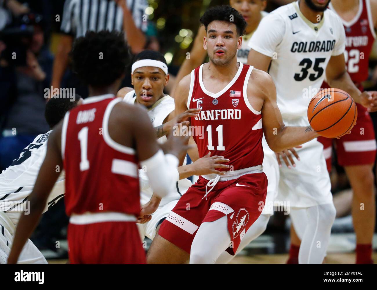 Stanford guard Dorian Pickens, back right, looks to pass the ball to ...