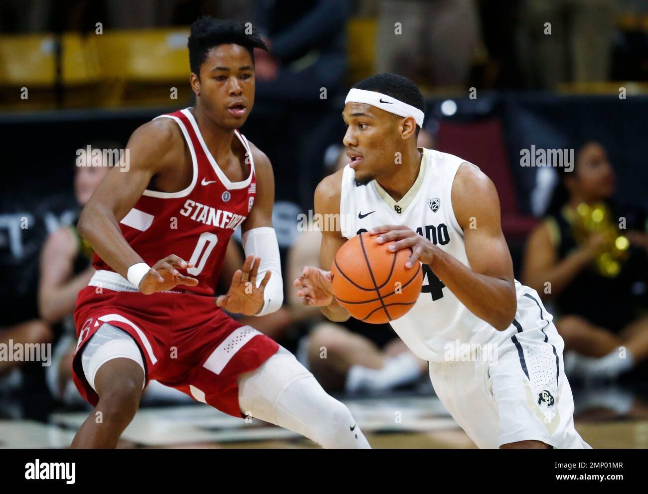 Colorado guard George King, right, drives past Stanford forward Kezie ...