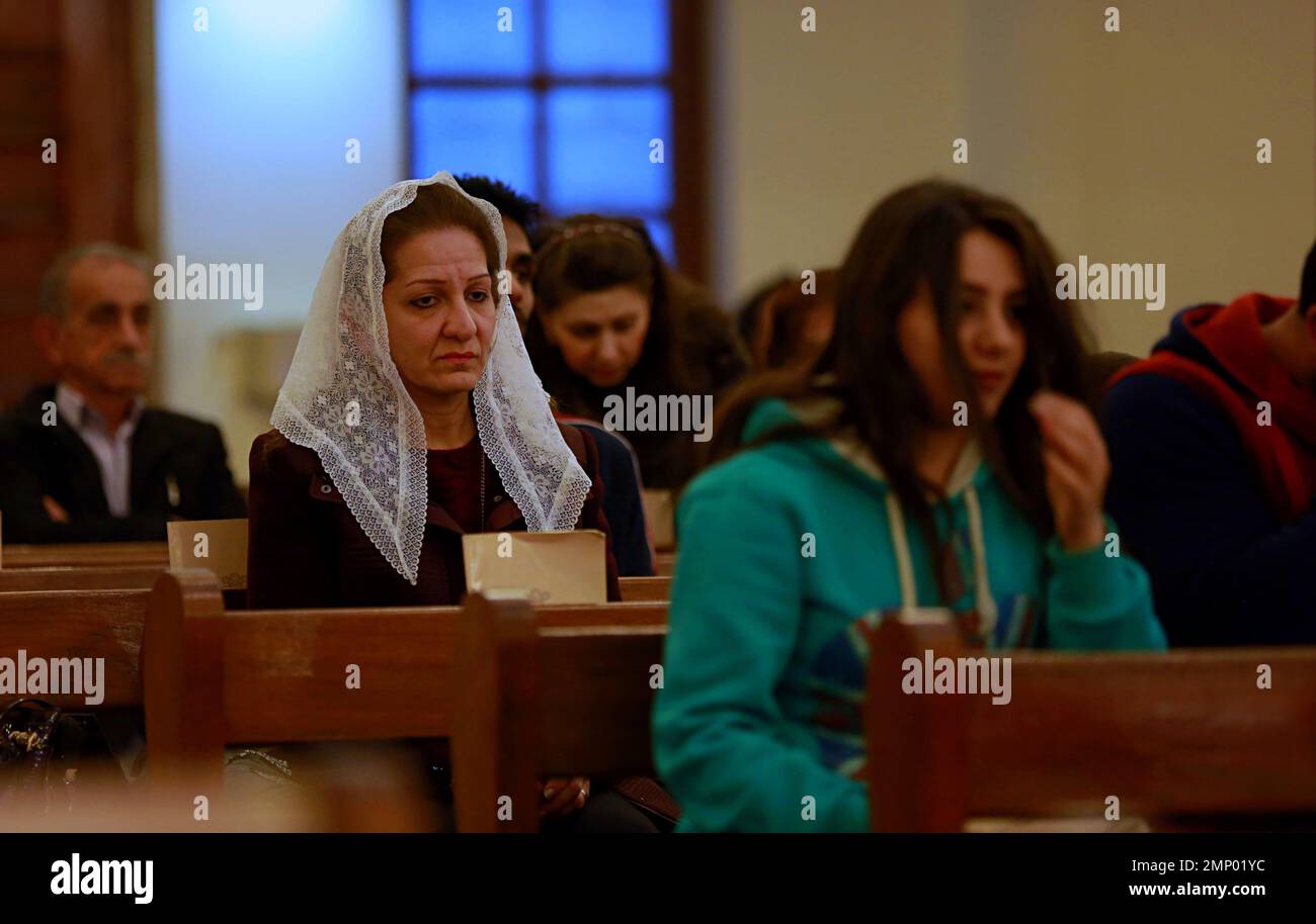 Iraqi Christians pray during Sunday Mass in the Virgin Mary church in ...