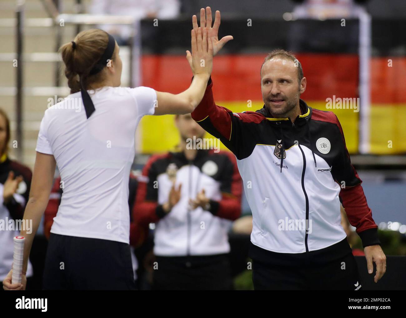 Antonia Lottner of Germany high fives with team captain Jens Gerlach ...