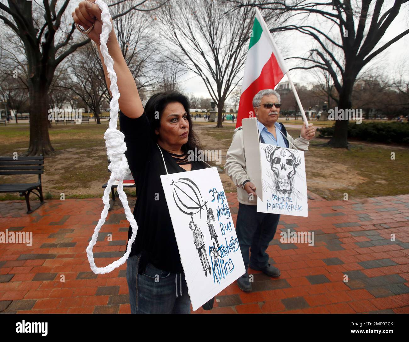 Holding a noose and signs people rally in support of the recent ...