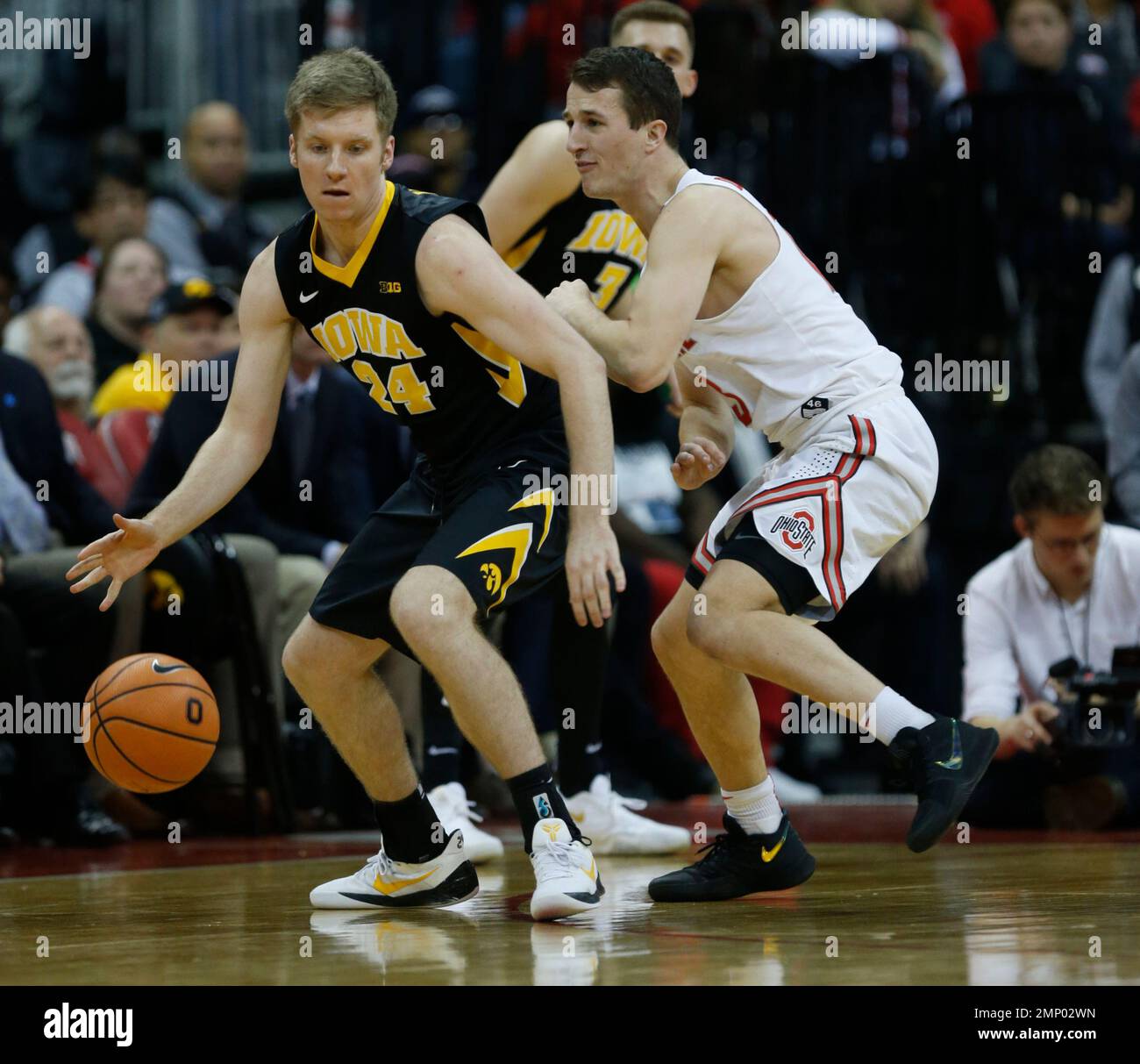 Iowa guard Brady Ellingson, left, works against Ohio State guard Andrew ...