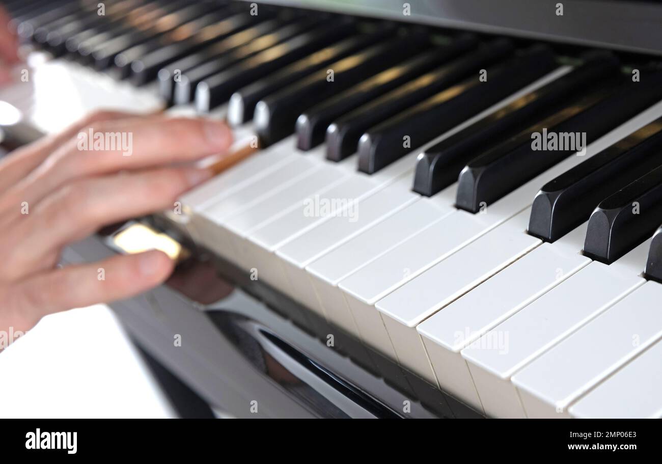 Hands playing music on the piano, selective focus Stock Photo - Alamy