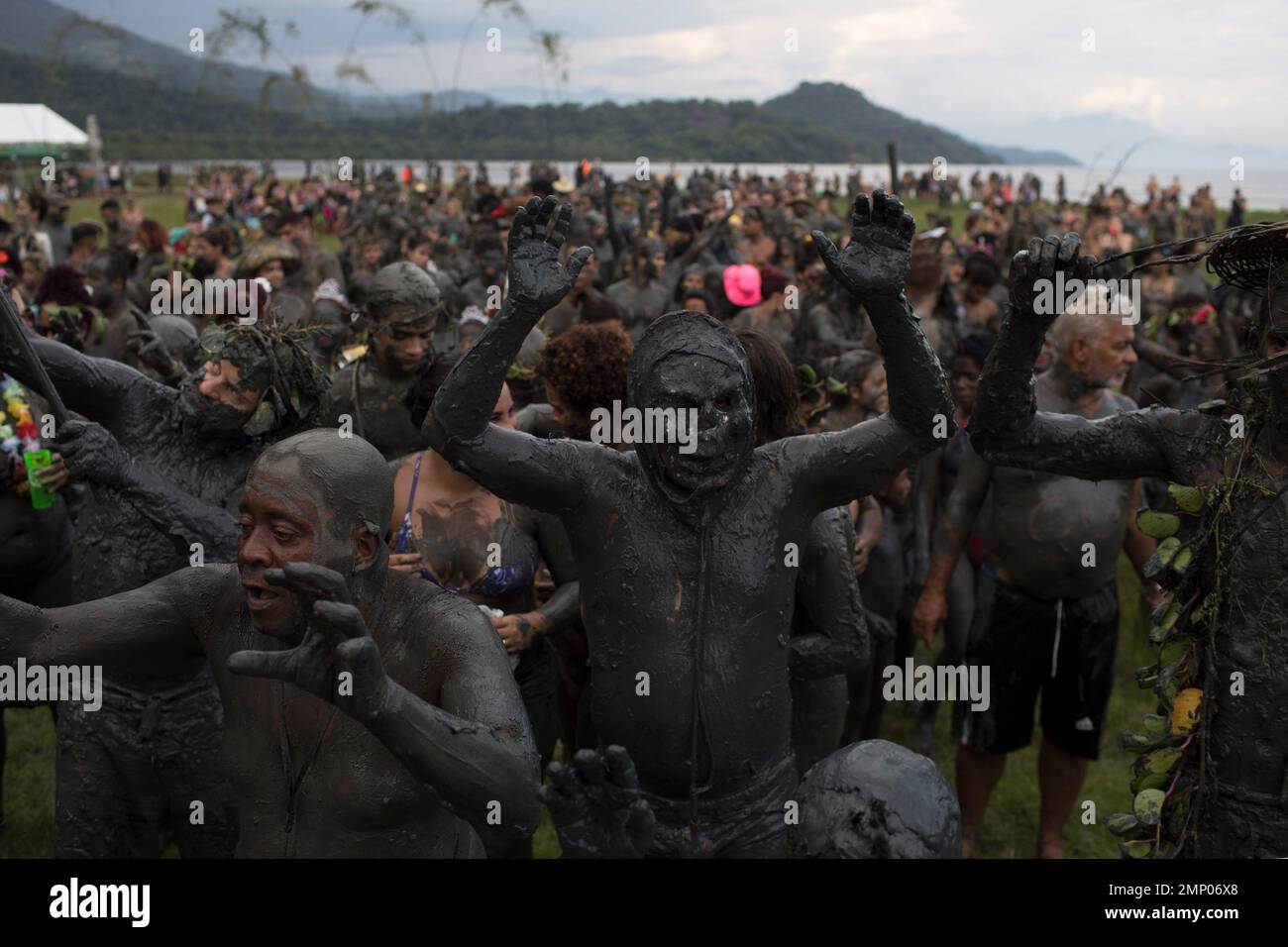 People covered in mud take part in the traditional "Bloco da Lama" or ...