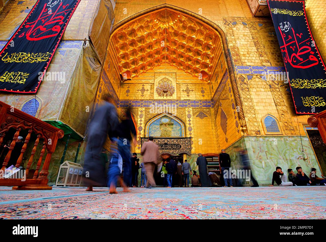 Shiite faithful pray at the holy shrine of Imam Ali, the son-in-law and ...