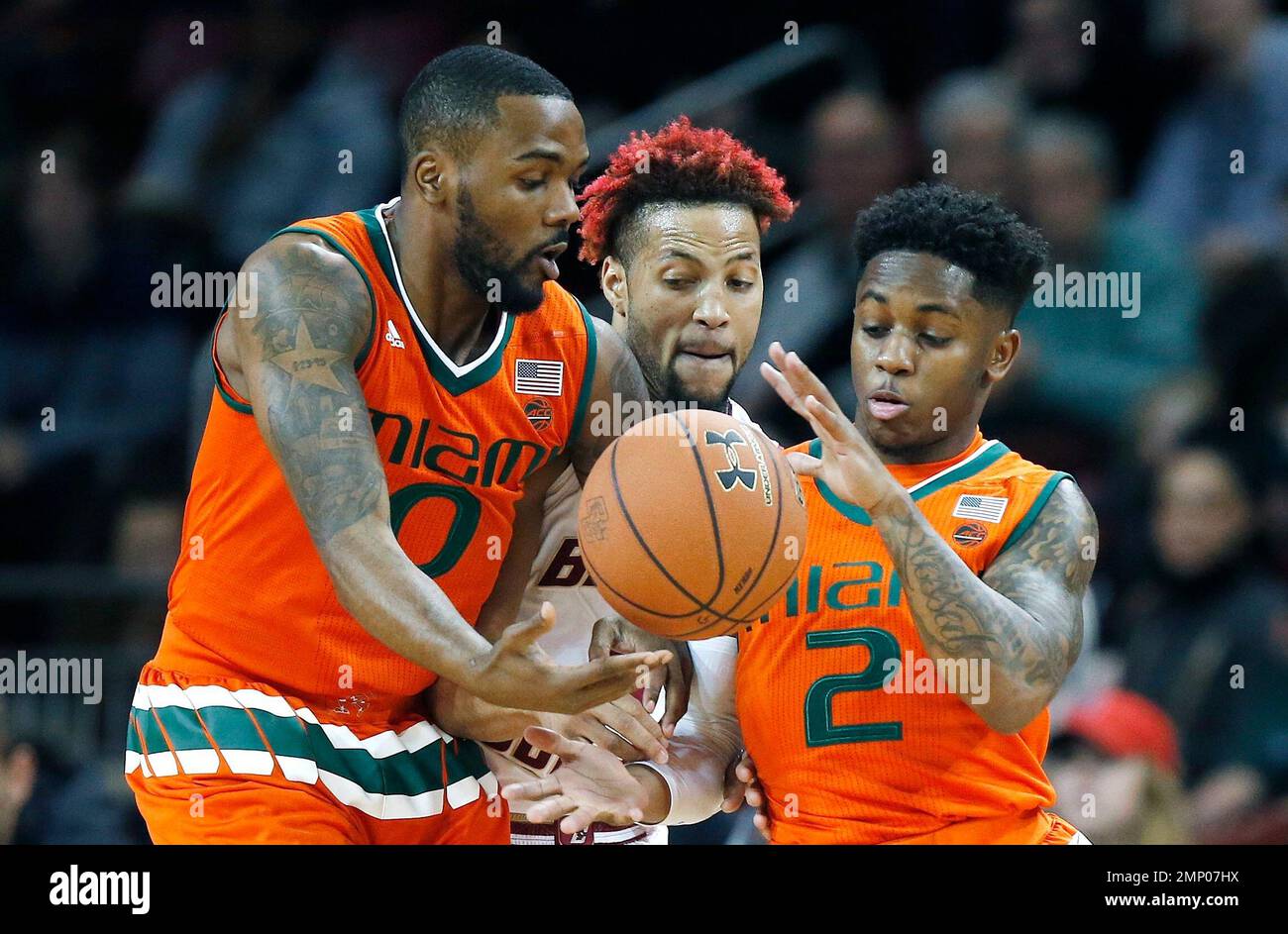 Boston College's Ky Bowman, center, battles Miami's Ja'Quan Newton (0 ...