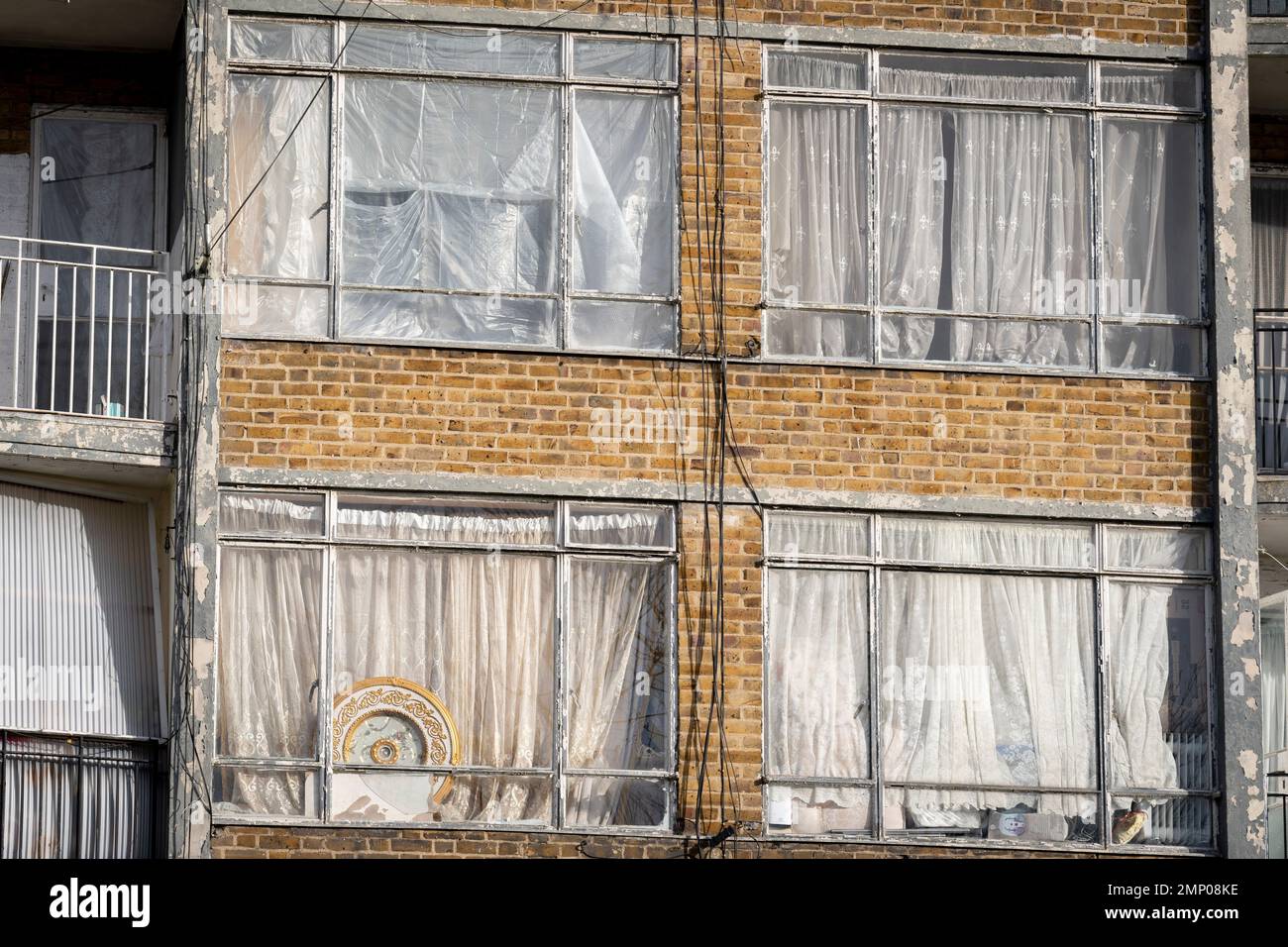 Dirty windows and closed curtains obscure the interiors of rented flats ...