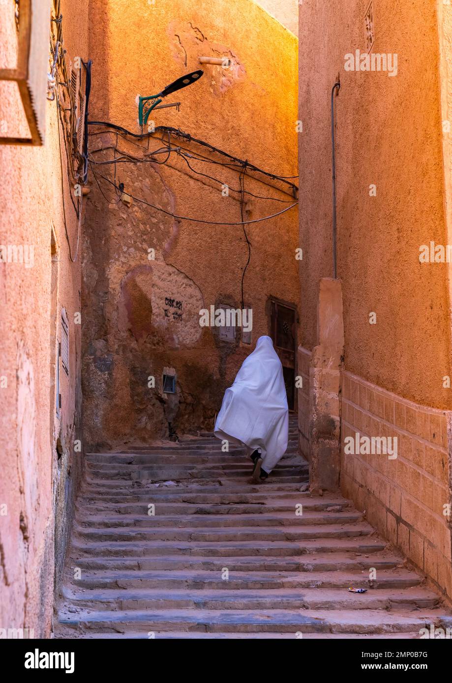 Mozabite woman in white haïk in the streets of Ksar El Atteuf, North ...