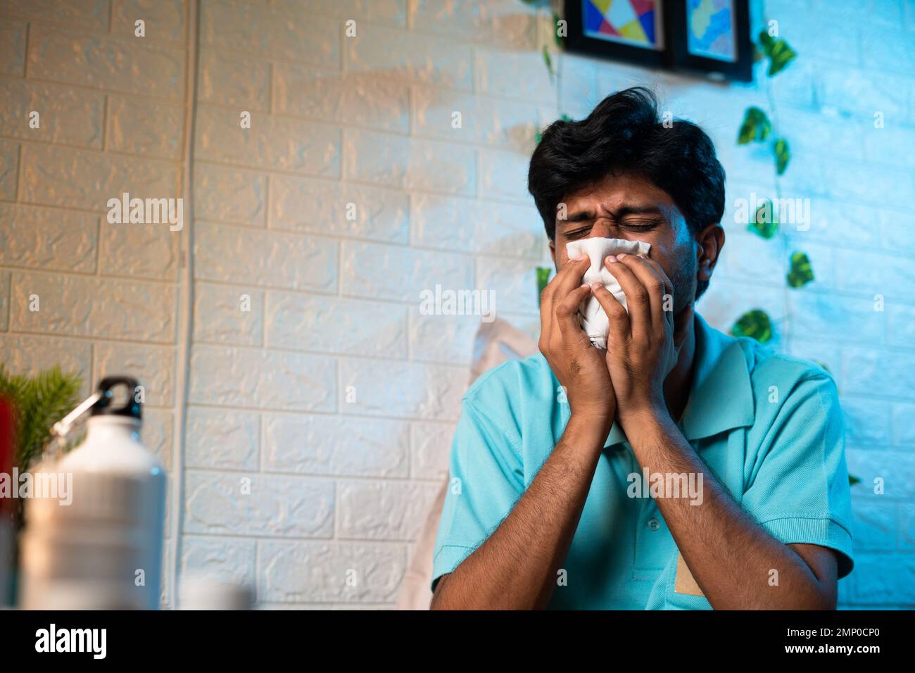 Sick man with cold sneezed into napkin during midnight at home ...