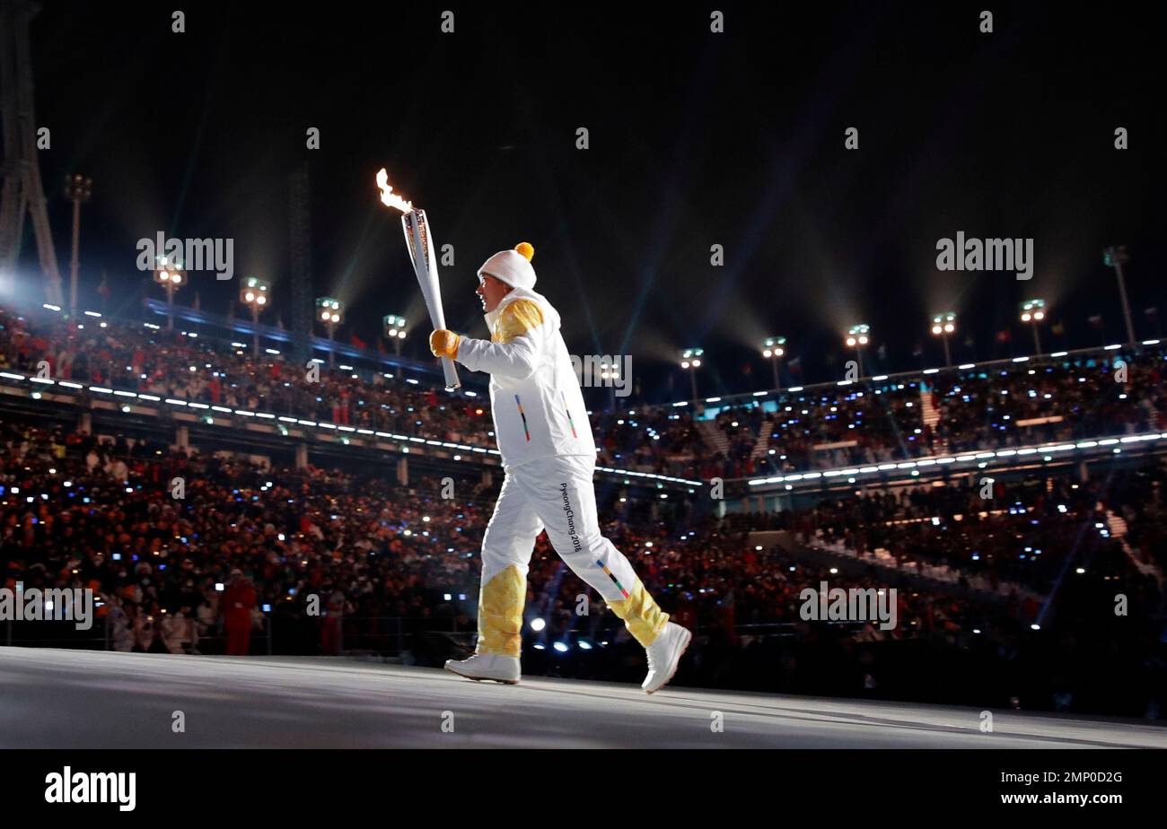 The Olympic torch is carried during the opening ceremony of the 2018 ...