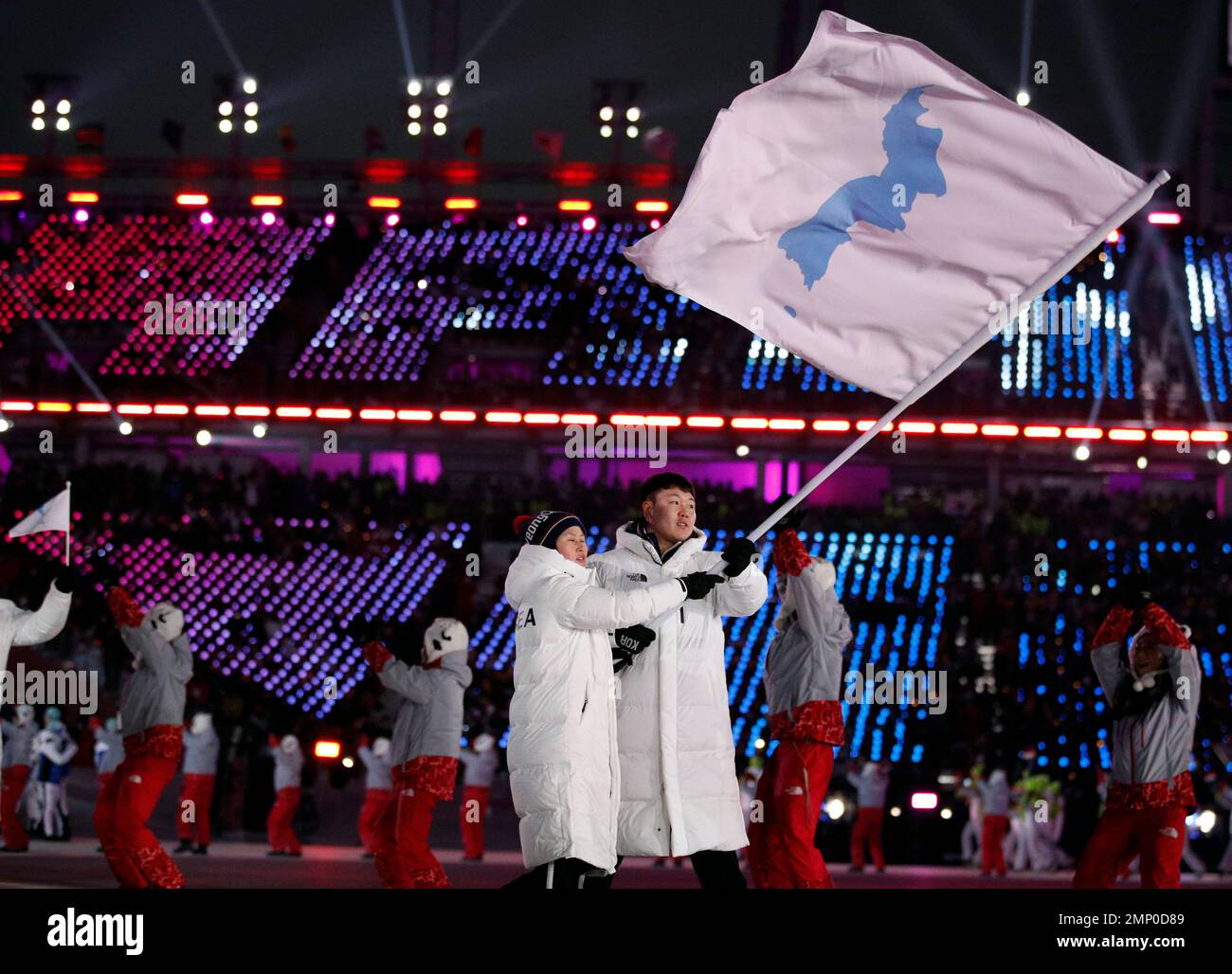 North Korea's Hwang Chung Gum and South Korea's Won Yun-jong carries ...