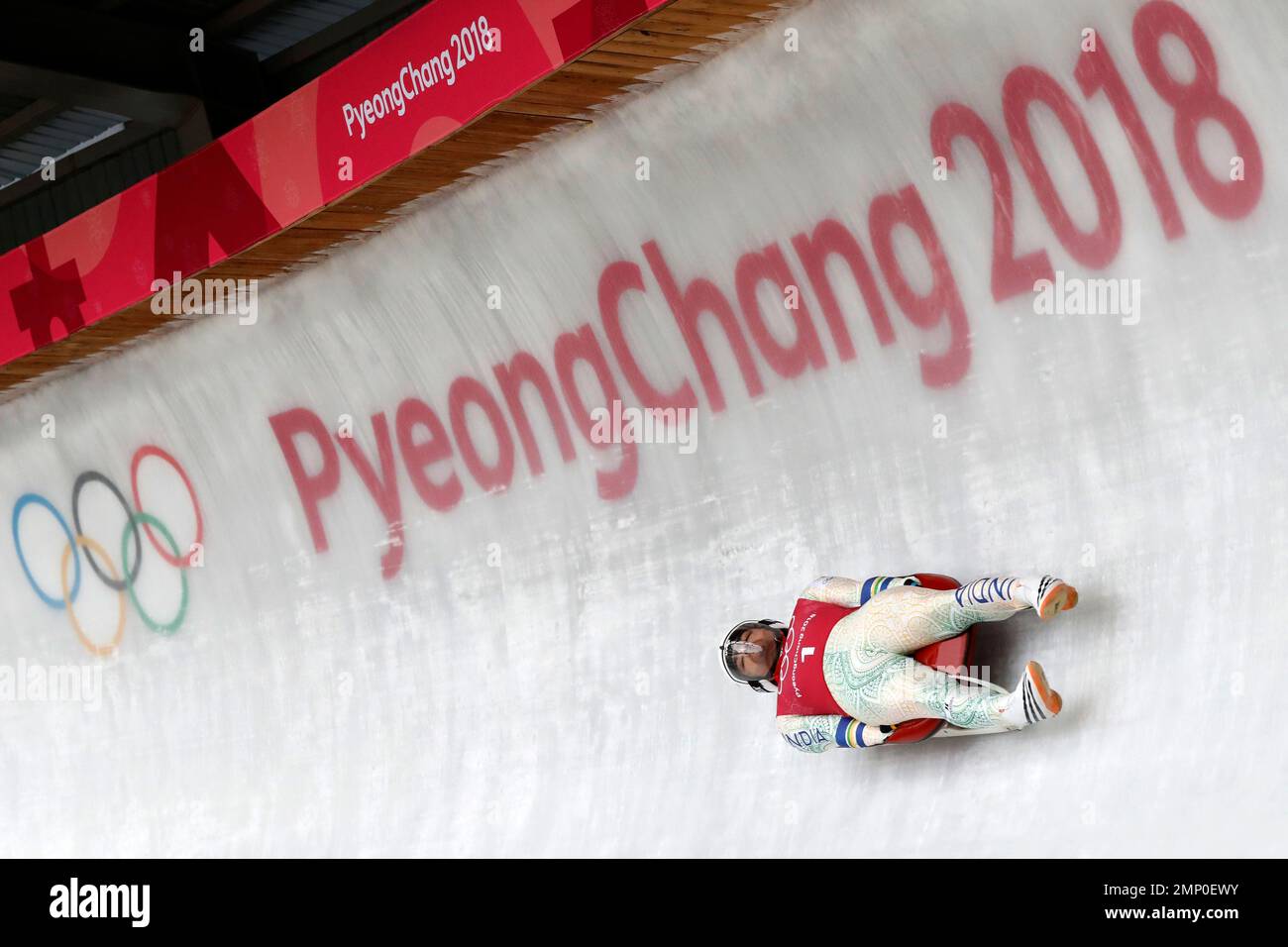 India's Shiva Keshavan speeds past the Olympic rings during the men's ...