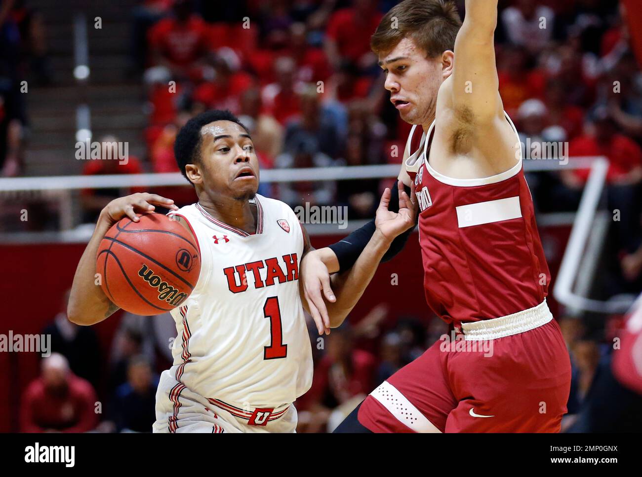 Utah guard Justin Bibbins (1) drives around Stanford guard Robert ...